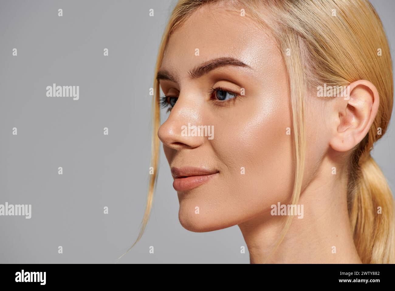 close up view of a blonde pretty girl in her 20s with confident look in ...