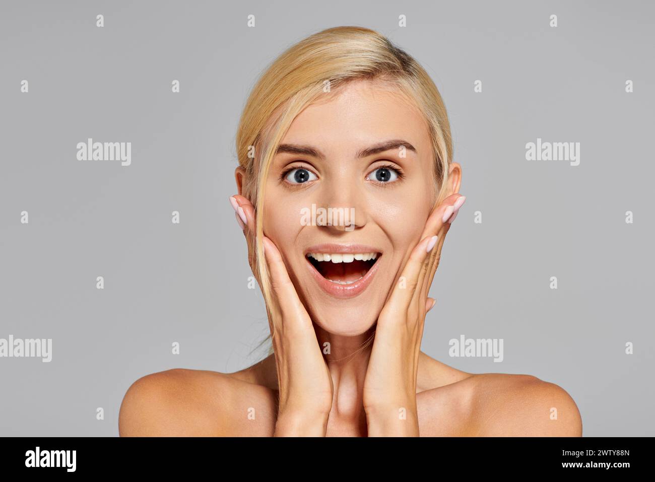 excited girl with blonde hair and gray eyes showing surprise face ...