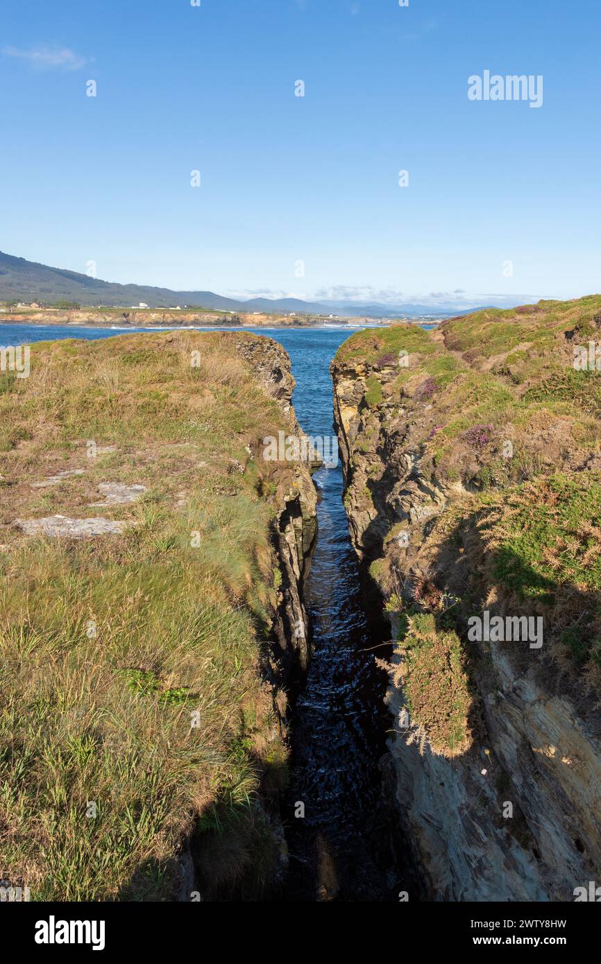 serene natural landscape with a narrow water channel leading to a ...