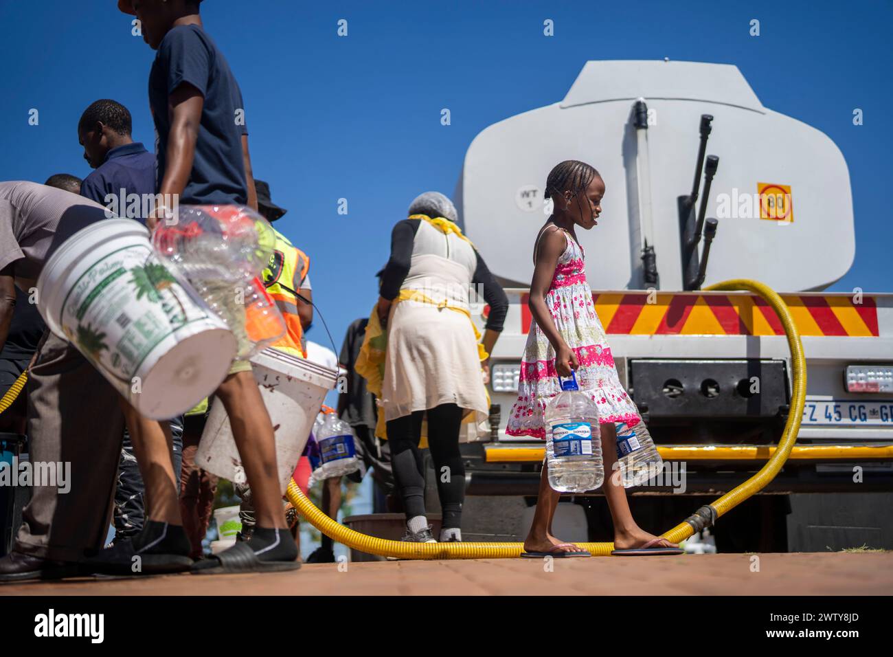 Residents of the township of Soweto, South Africa, queue for water ...
