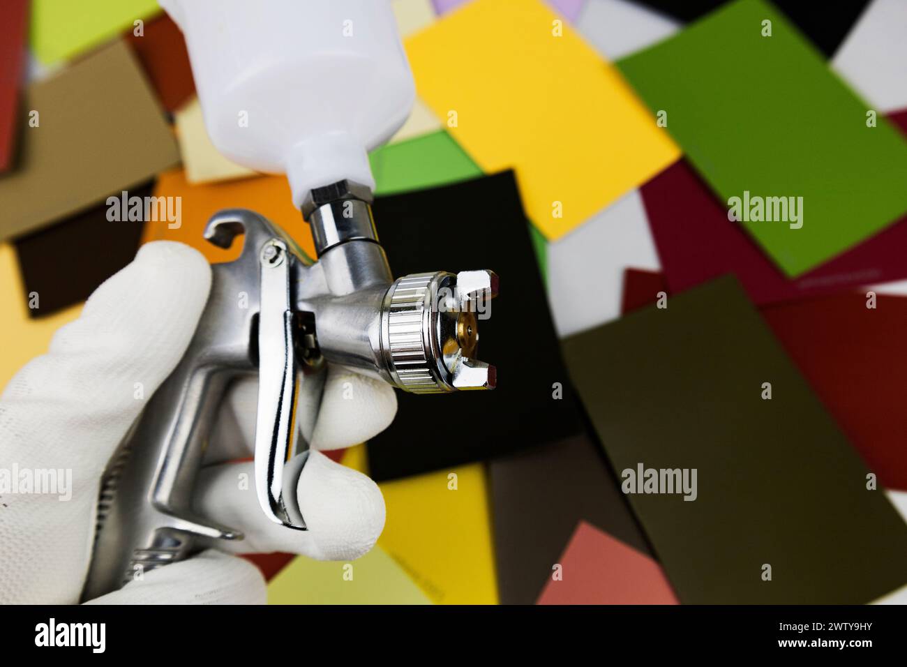 paint spray gun at work at the workplace in the workshop, selection of ...