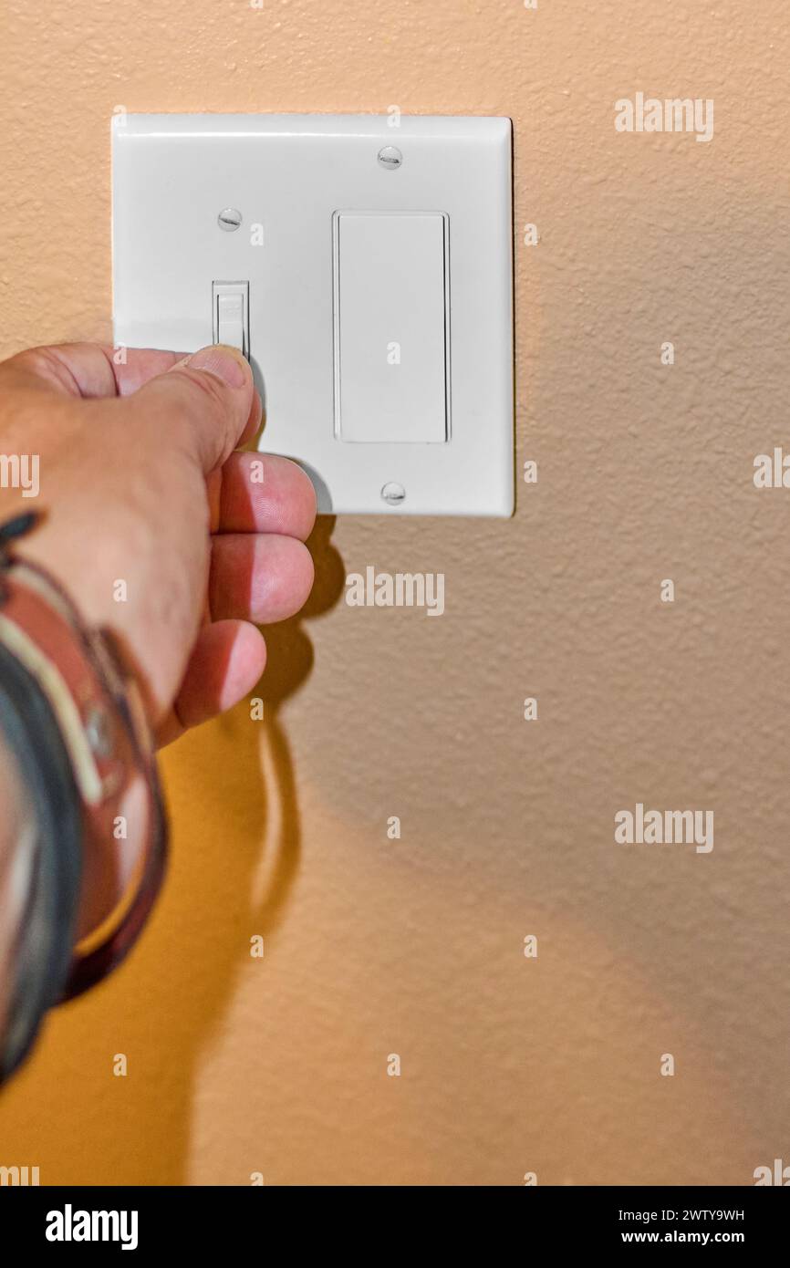 Electrical switch with finger pressing it Stock Photo - Alamy
