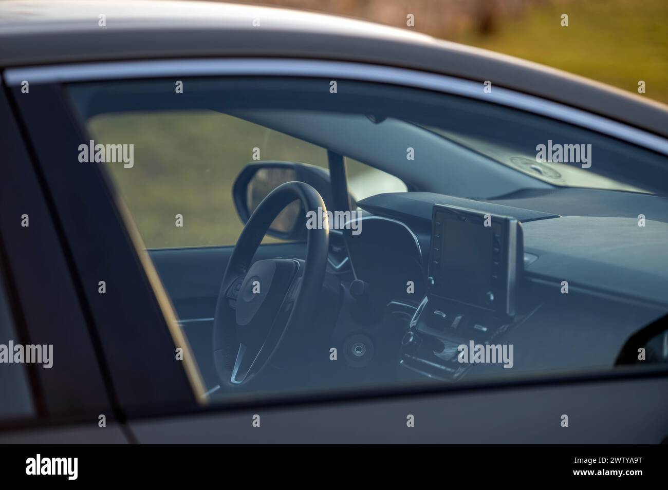 Modern car interior with steering wheel and dashboard, shallow depth of ...