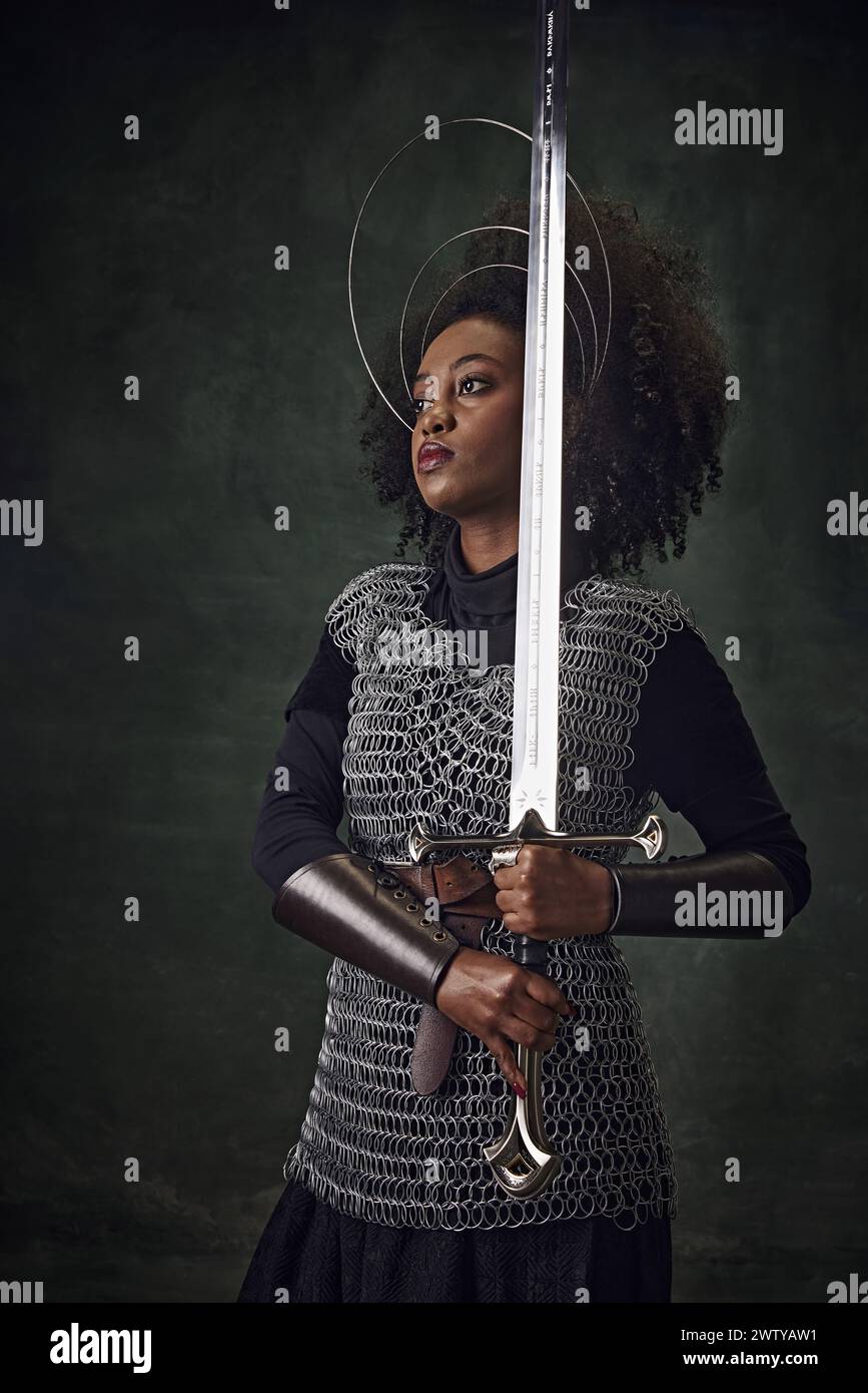 Elegant young African-American woman in medieval chainmail armor with ...