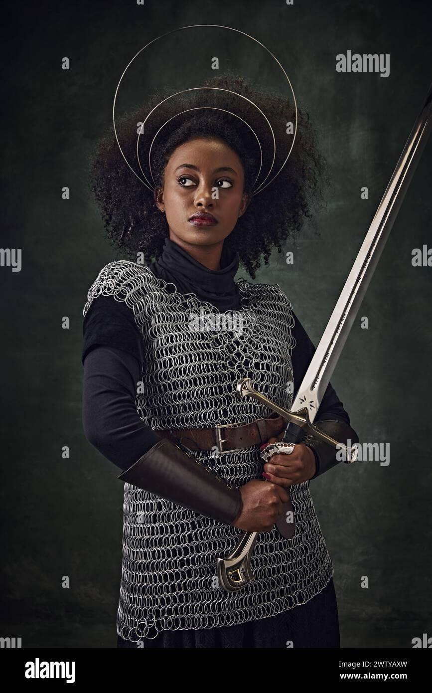 Serious, young African woman, medieval warrior in chainmail armor with ...