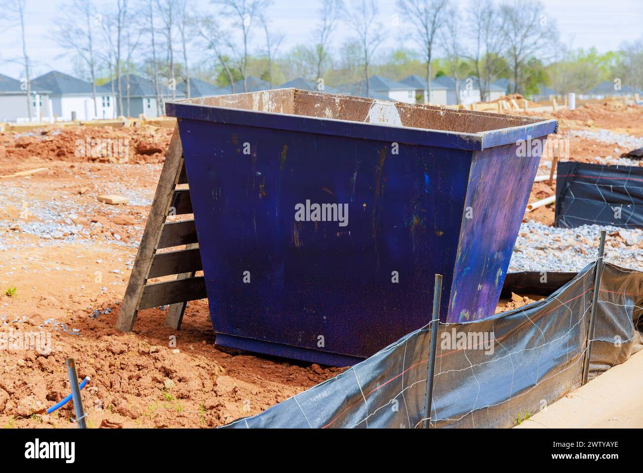 At construction site, metal container dumpster is used to store ...