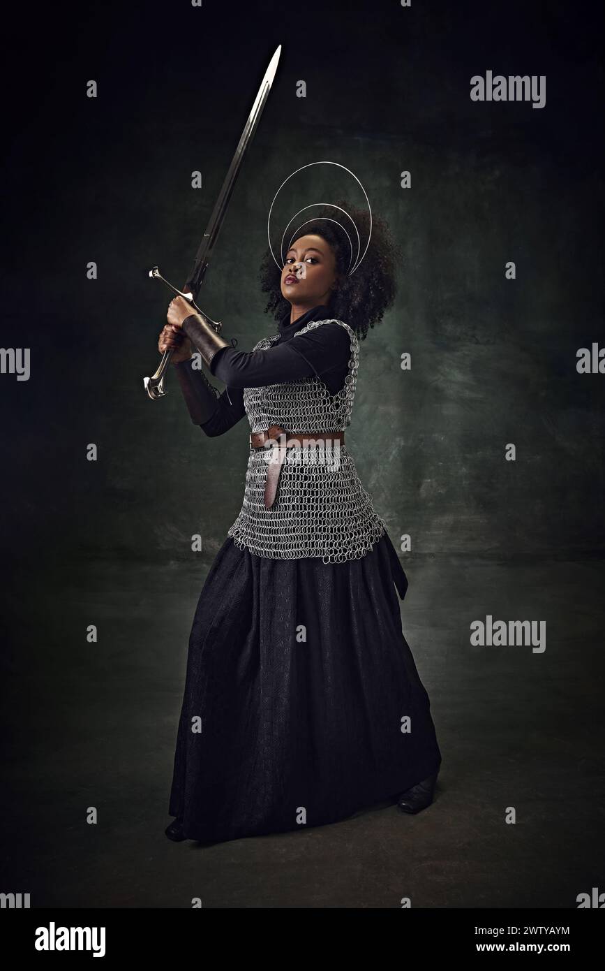 Brave young African woman, medieval warrior in chainmail armor with ...