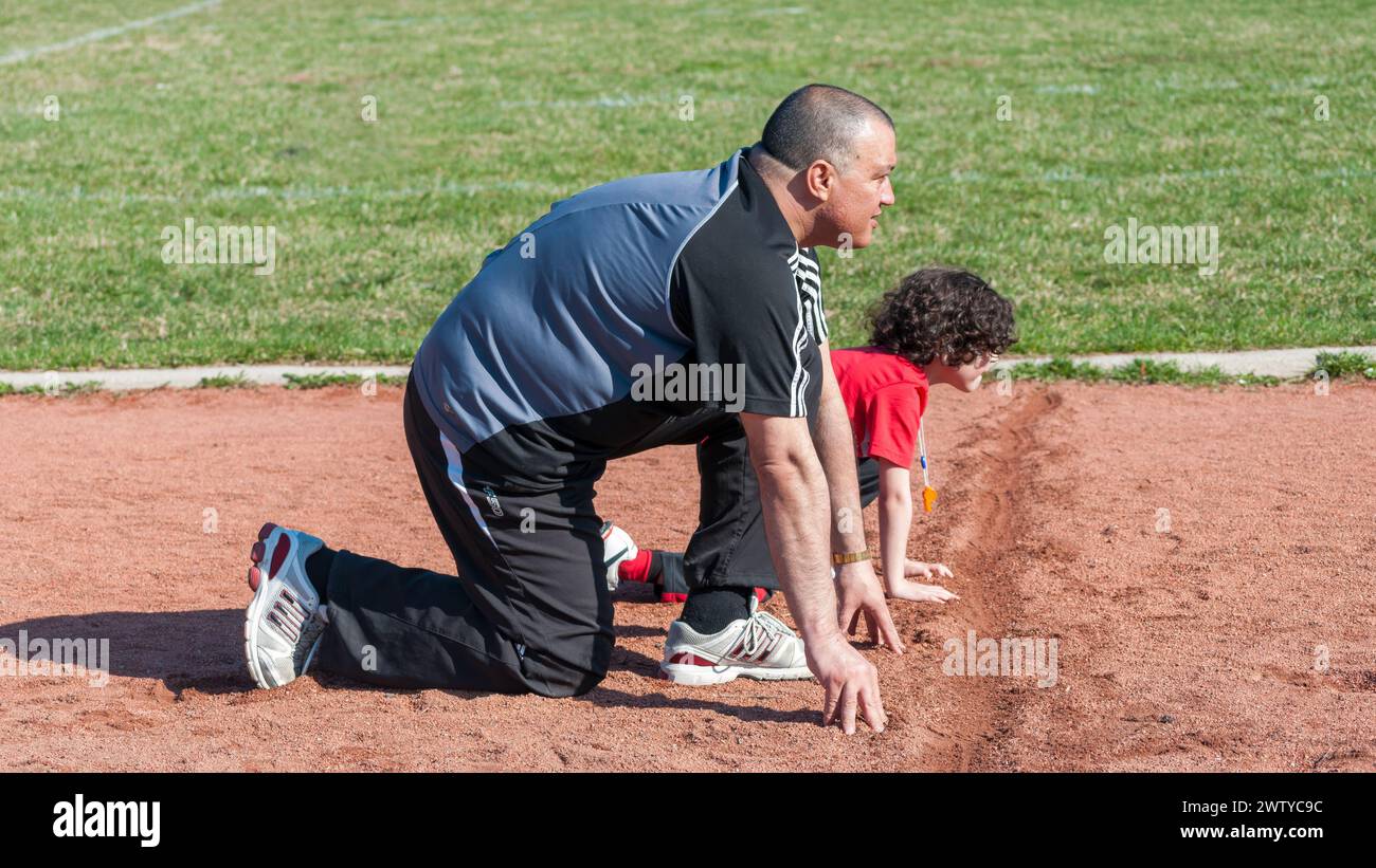 Latin American father and boy child playing to race on a track Stock ...