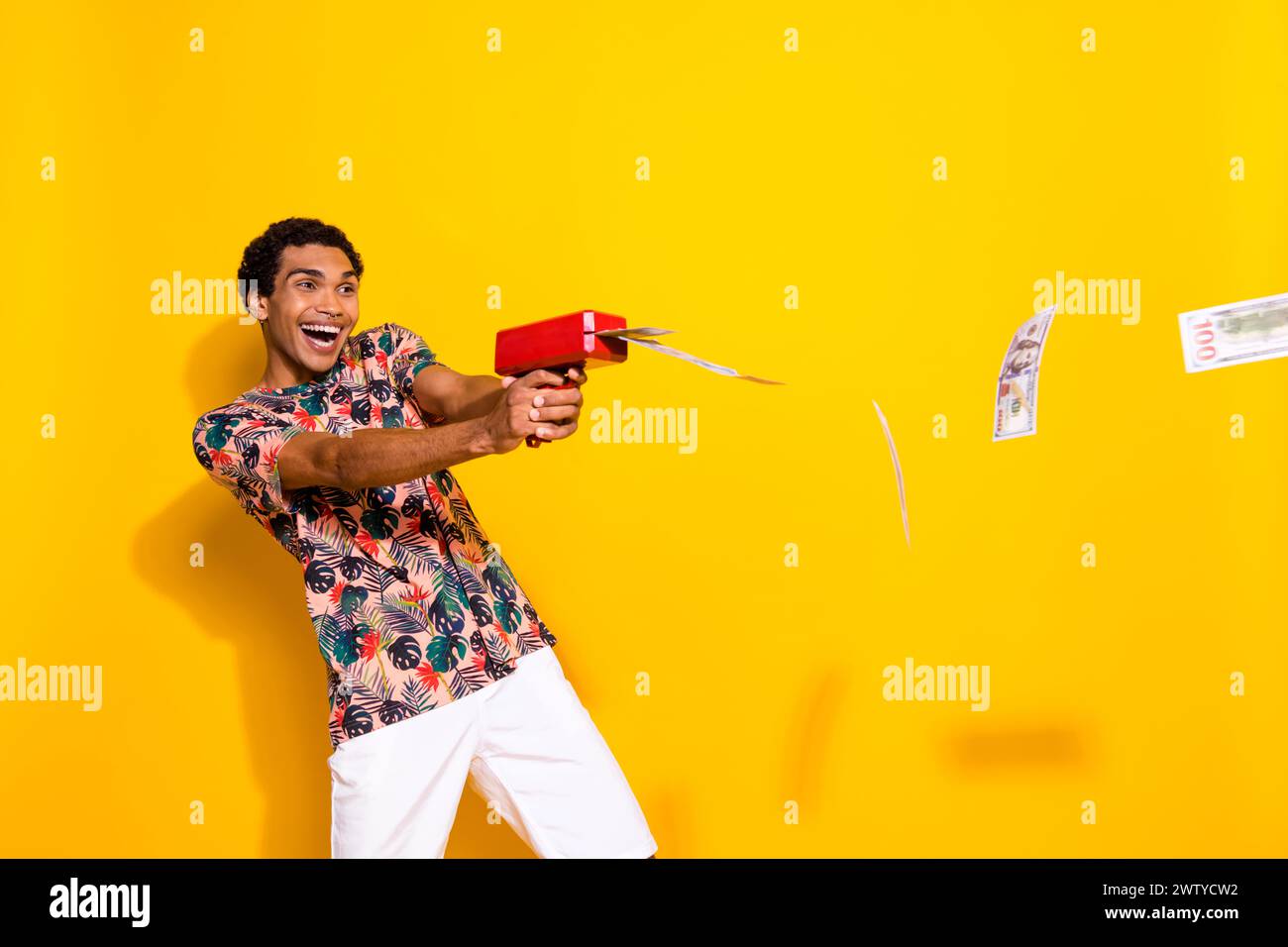 Photo of successful young rich guy millionaire shooting money machine ...