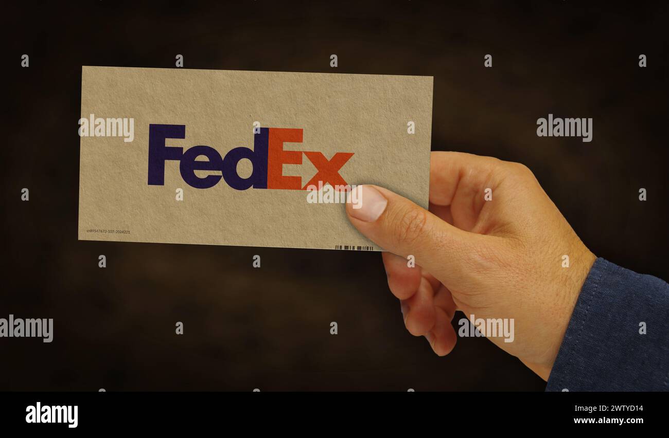 Poznan, Poland, March 12, 2024: Fedex delivery box in hand. Federal ...