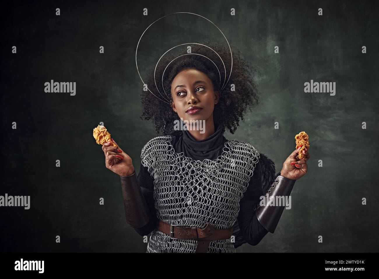 Young African woman, medieval warrior in chainmail armor holding fried ...