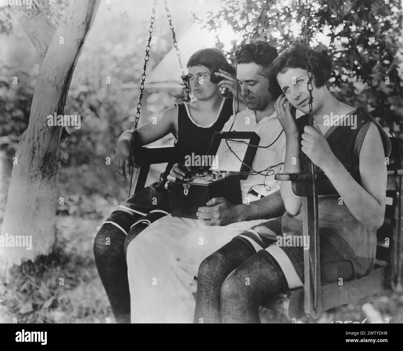 A Gay Afternoon In 1923 Cotton Stocking Period With This Trio Listening In On A One Tube Set