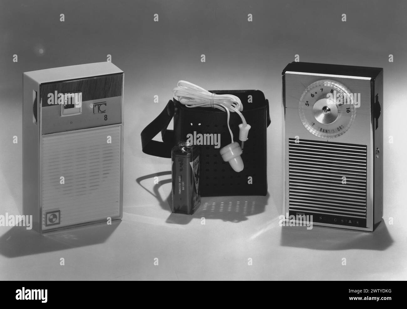A couple of portable AM transistor radios, showing a case, a 9 volt ...