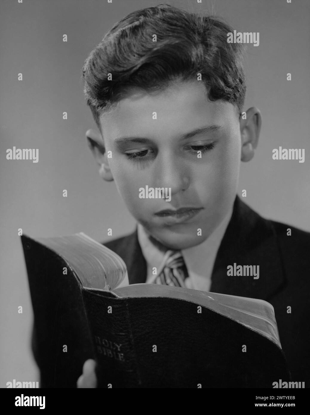 Boy reading bible hi-res stock photography and images - Alamy
