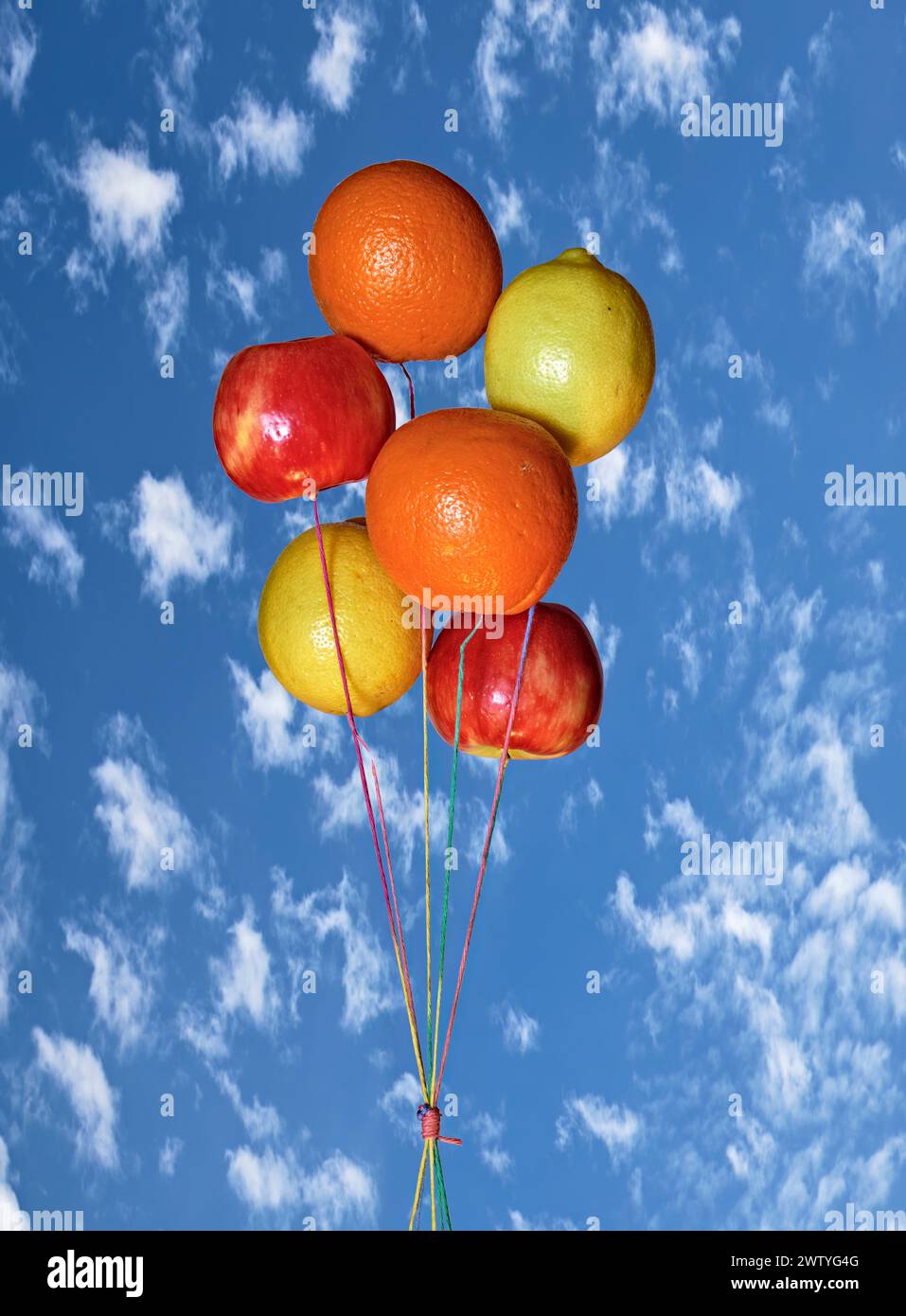 Apples,oranges and lemons made to look like balloons. On a bright sky ...