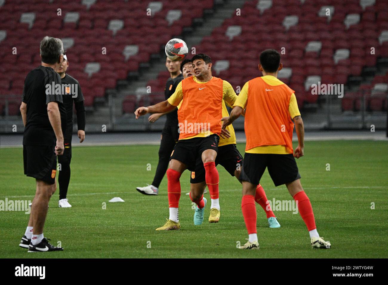 Singapore. 20th Mar, 2024. China's Ai Kesen (2nd R) vies for the ball ...