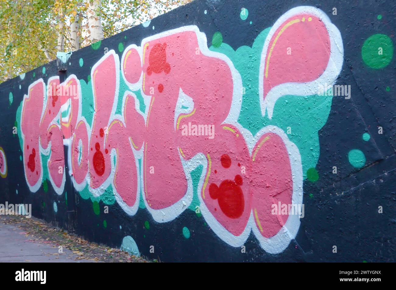 The old wall decorated with paint stains in the style of street art ...