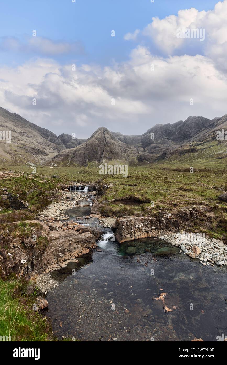 A vertical perspective of the tranquil Fairy Pools with a small cascade ...