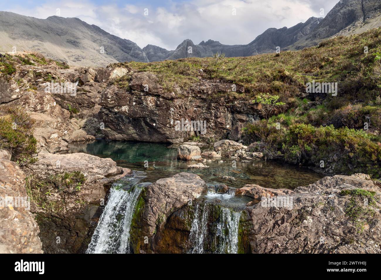 The Fairy Pools unveil a tranquil cascade, its waters merging with a ...
