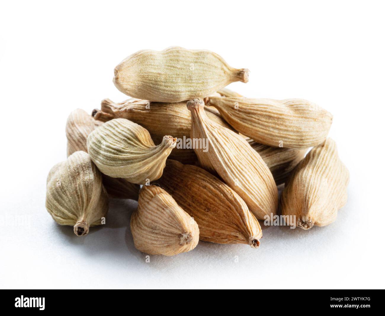 a bunch of cardamom spice isolated white background Stock Photo - Alamy