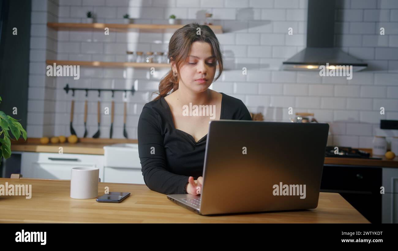 Frustrated woman receives bad news sees shocking information on laptop ...