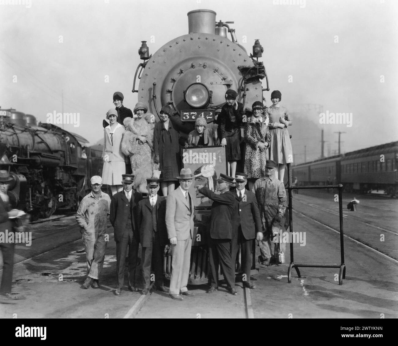 Group of passengers and conductors posing in front of the first fast ...
