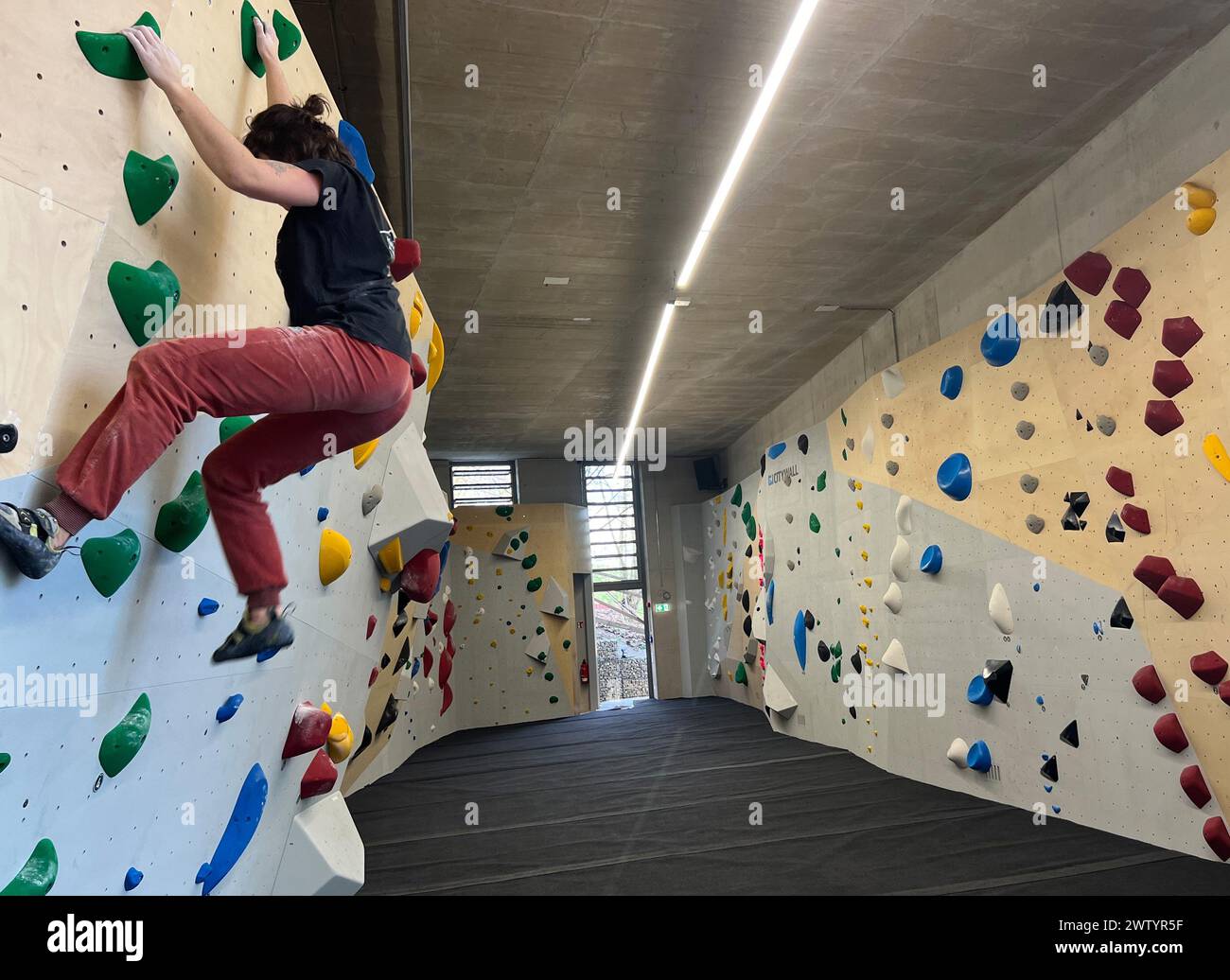 Munich, Germany. 20th Mar, 2024. A woman climbs in the new bouldering ...