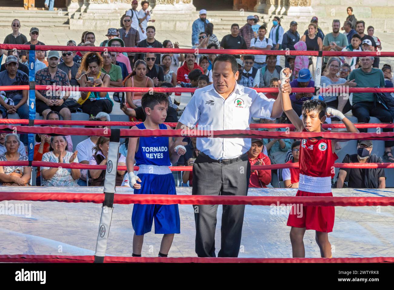 Oaxaca, Mexico - The referee declares the winner in a youth boxing ...