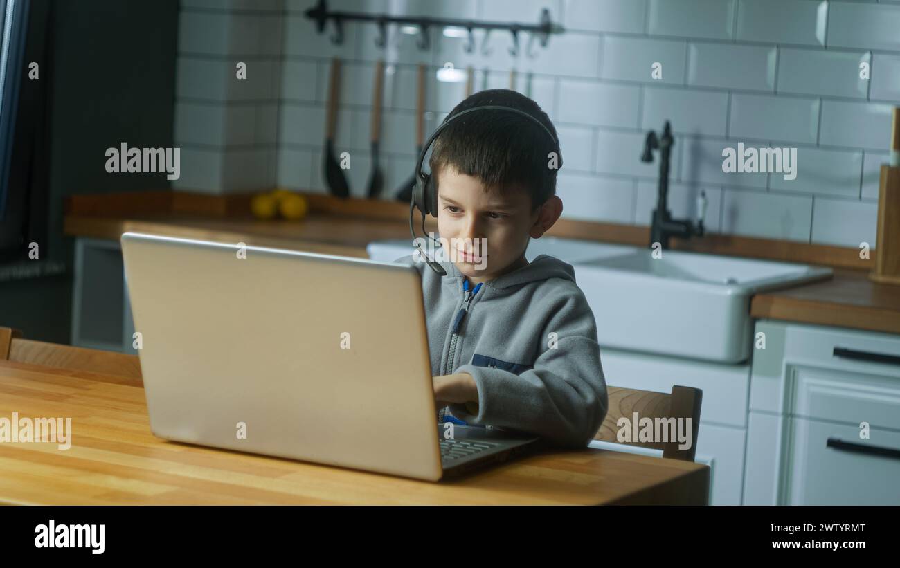 Student kid wear wireless headset making video call with laptop ...
