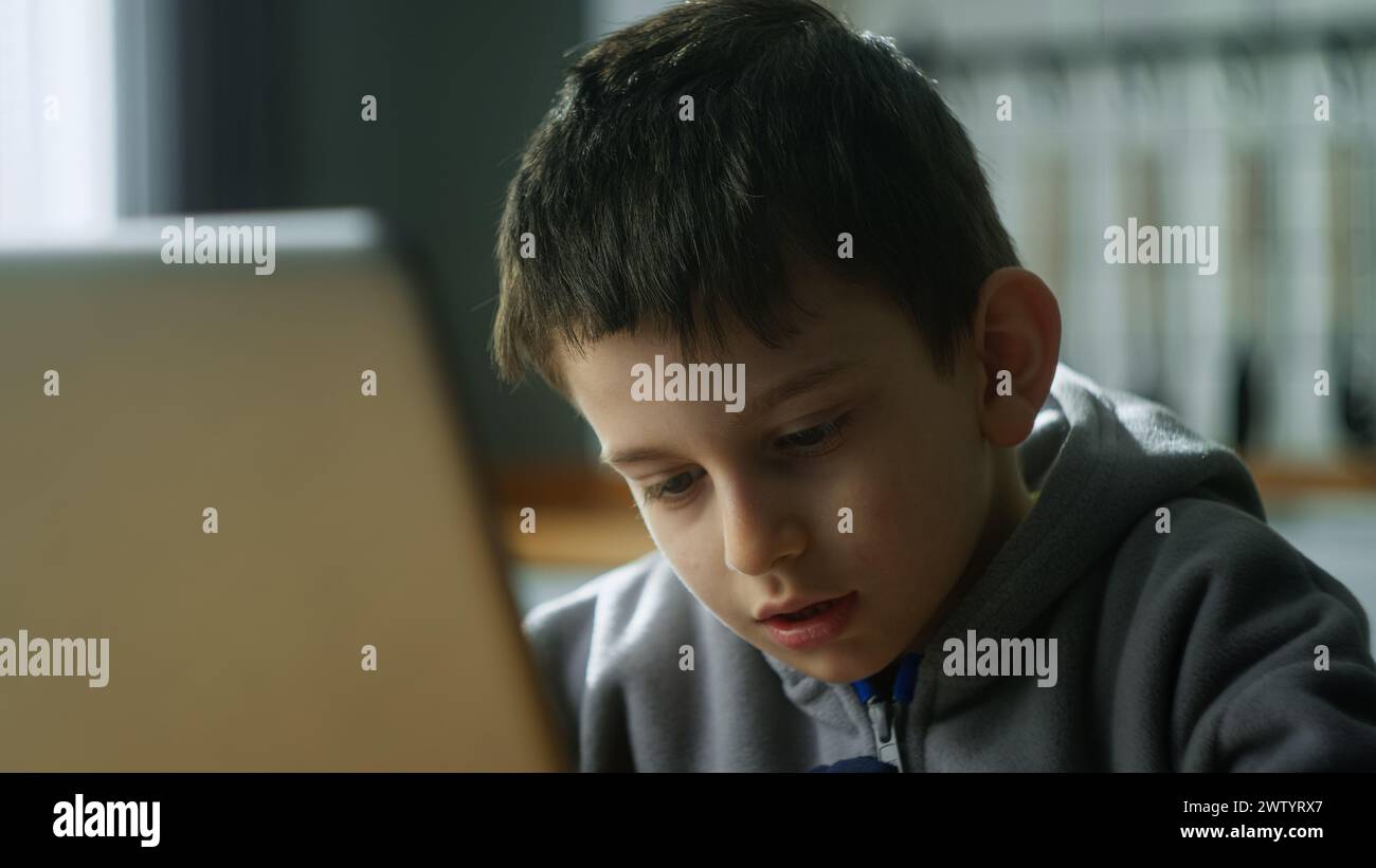 Close-up of boy typing on laptop keyboard. Kid using computer for ...