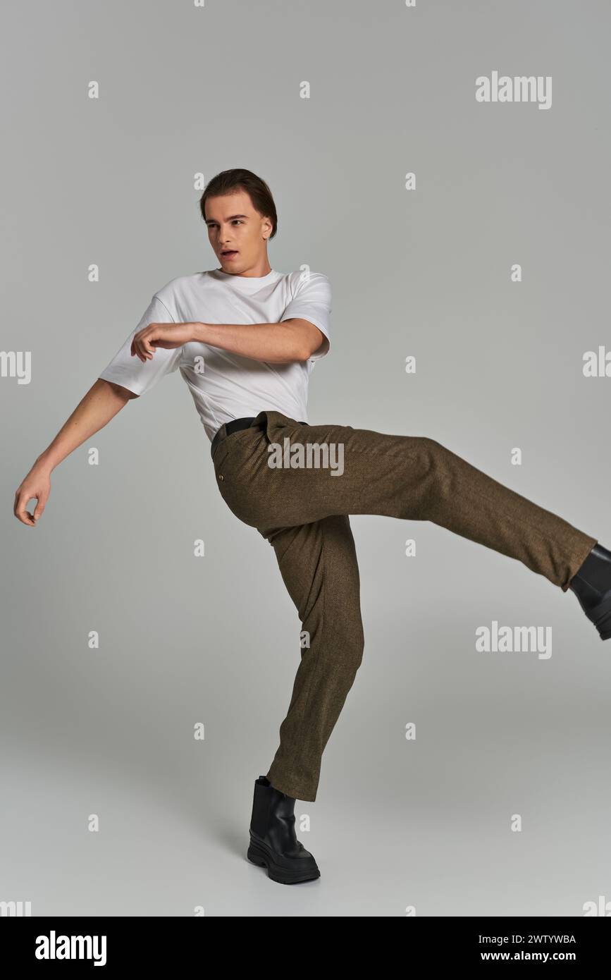 handsome elegant male model in stylish attire posing in motion and ...