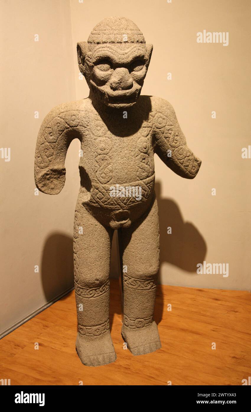 Pre-Columbian stone sculpture of a male figure with an elaborate feline ...