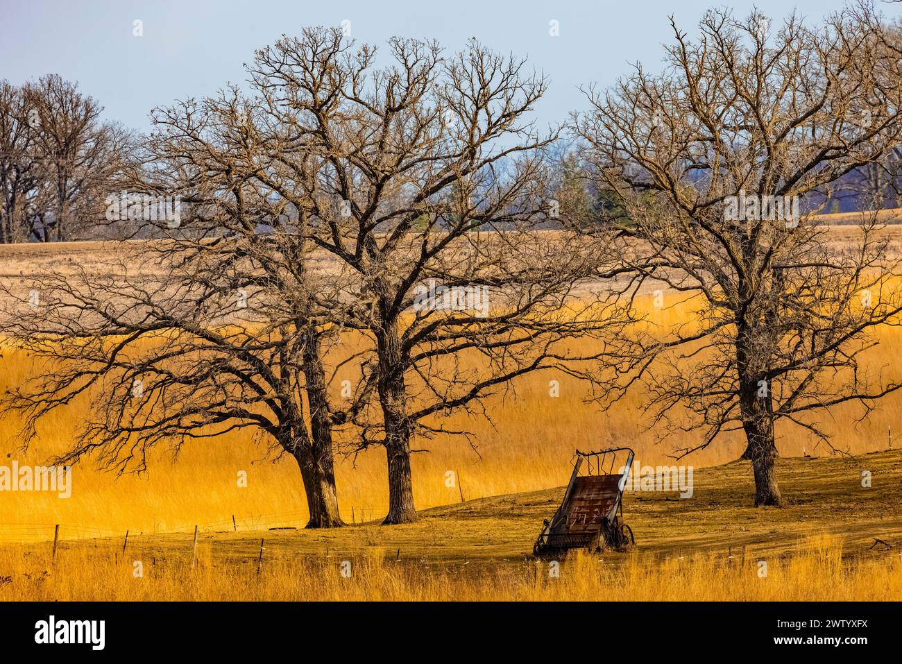 Prairie and trees with old hay loader on private land viewed from Pilot ...