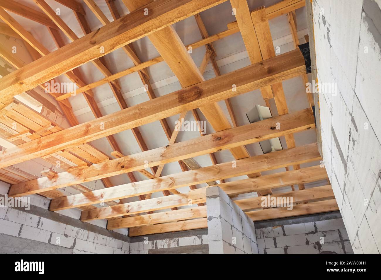 New construction of the house. Construction of a wooden roof from beams ...