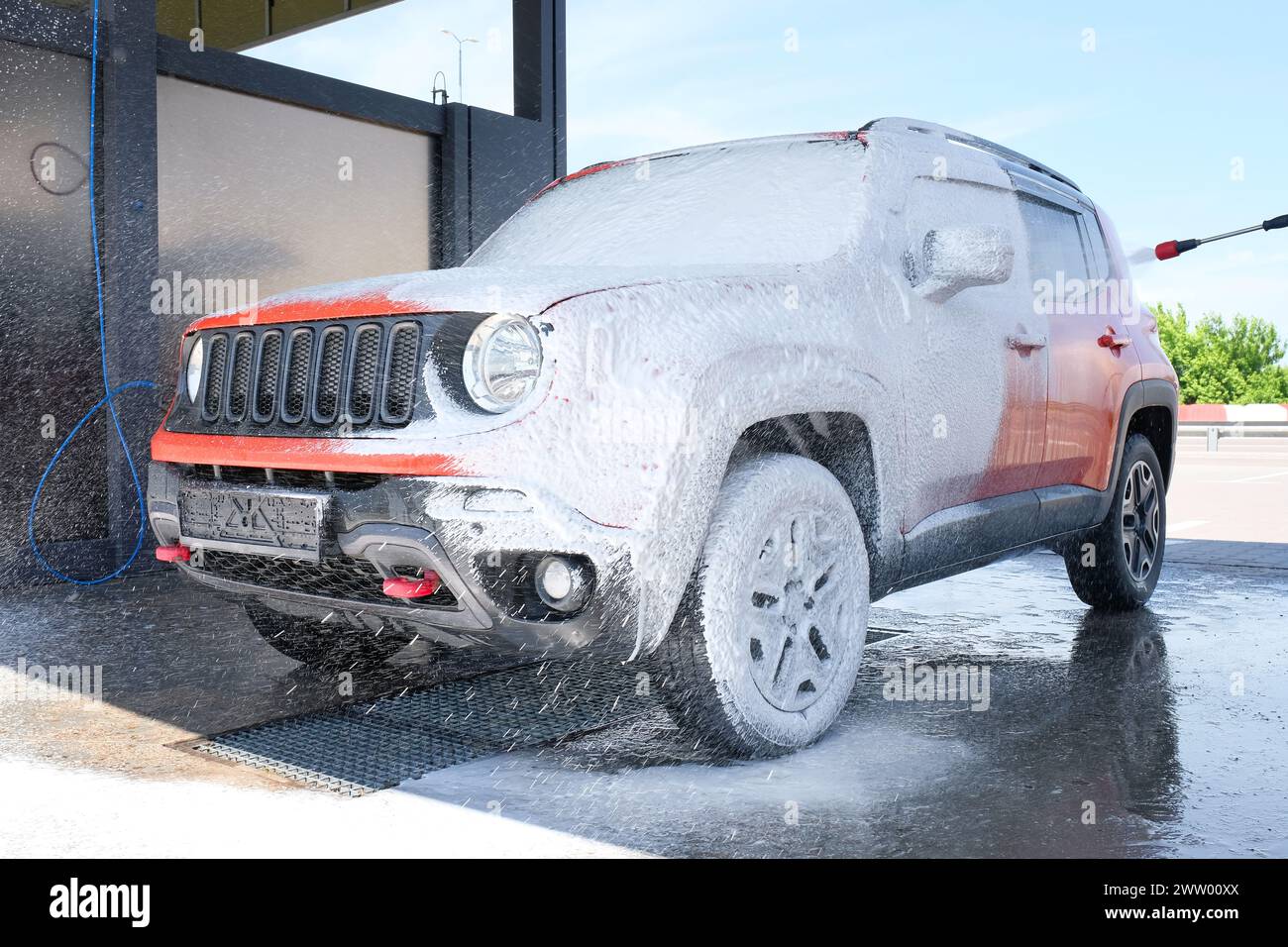 Car in foam. Car getting a wash with soap, car washing Stock Photo - Alamy