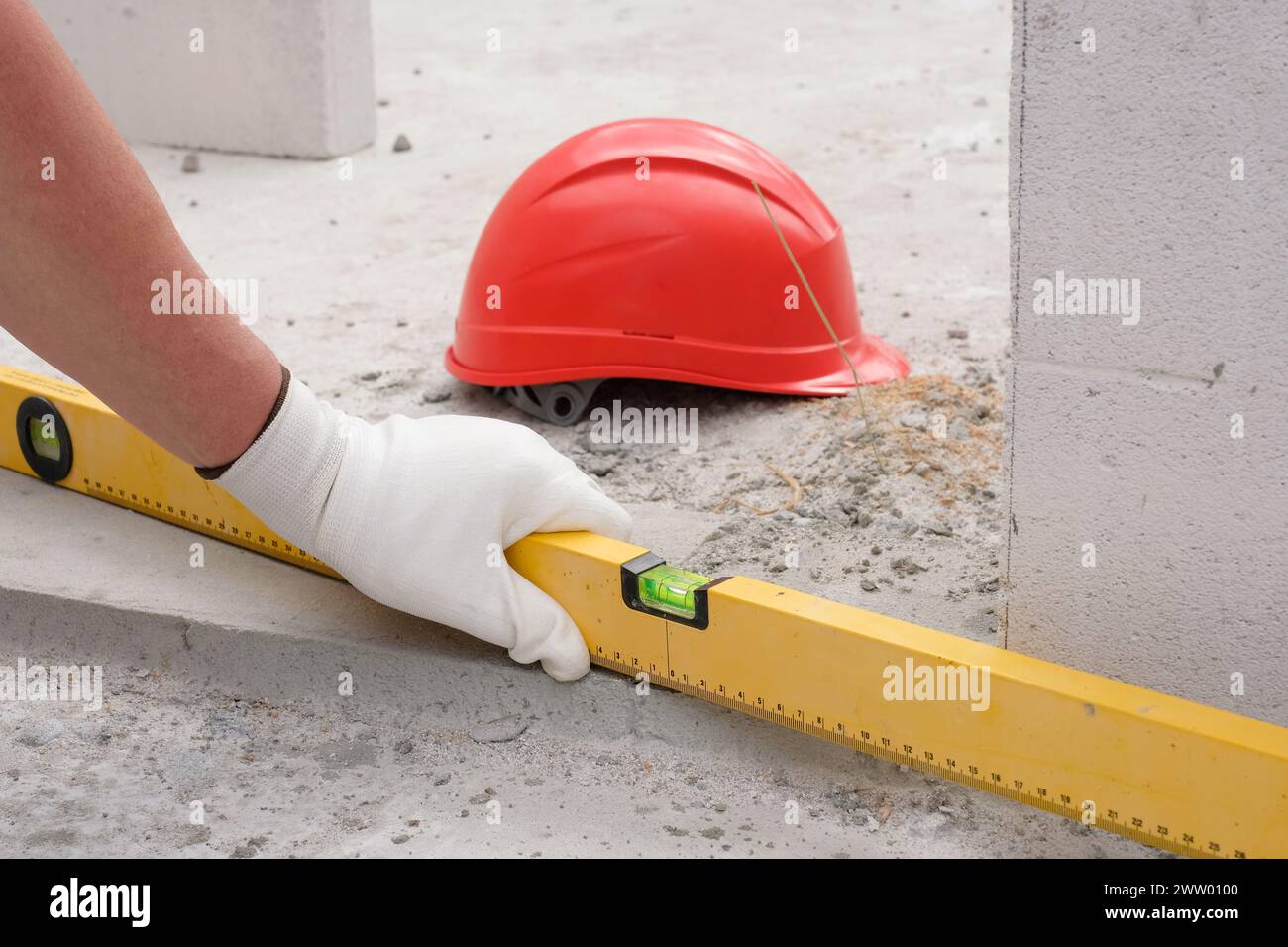 Construction level in the hand of a worker at the construction site of ...