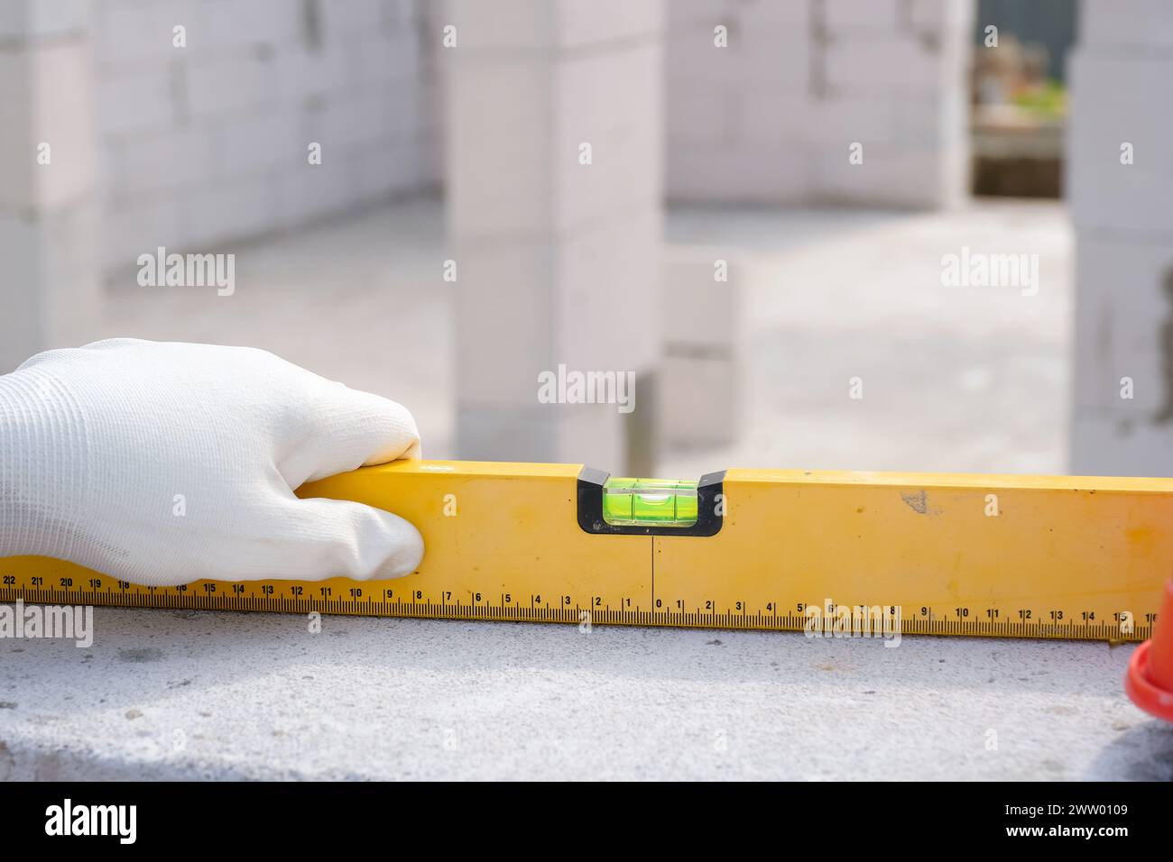 The hand of the builder measures the level of the plane using the ...