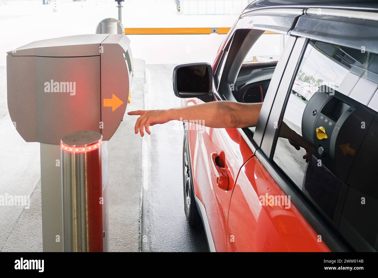 A man in a car drives into a parking lot Stock Photo - Alamy