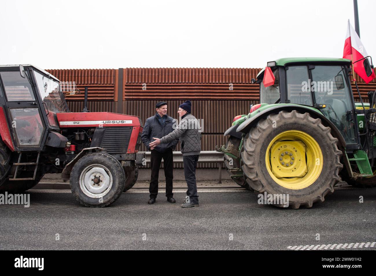 Protesting farmers are talking to each other during the road blockade ...