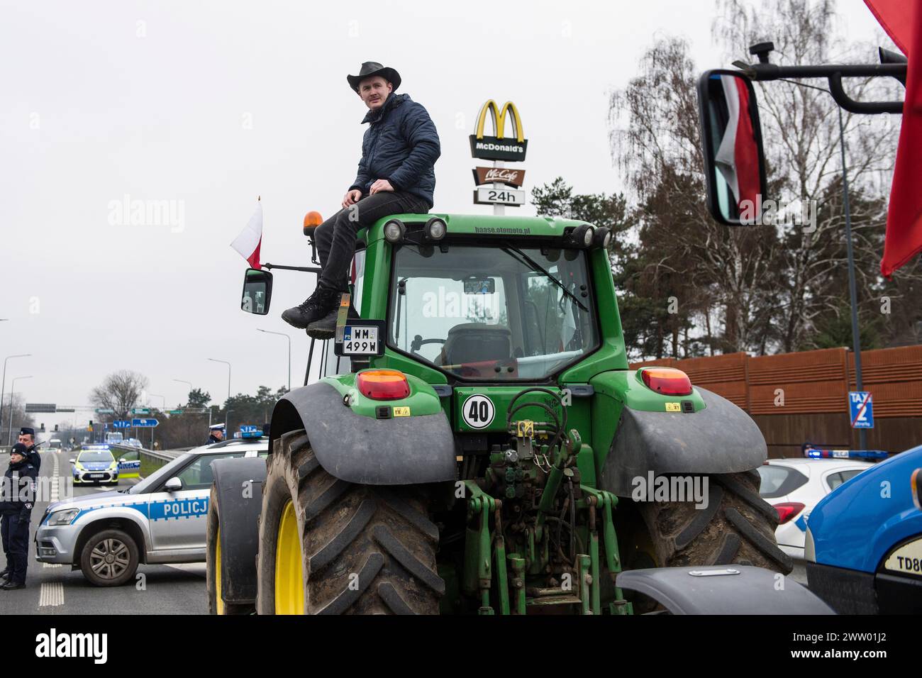 Protesting farmers are seen on the roof of their tractors during the ...