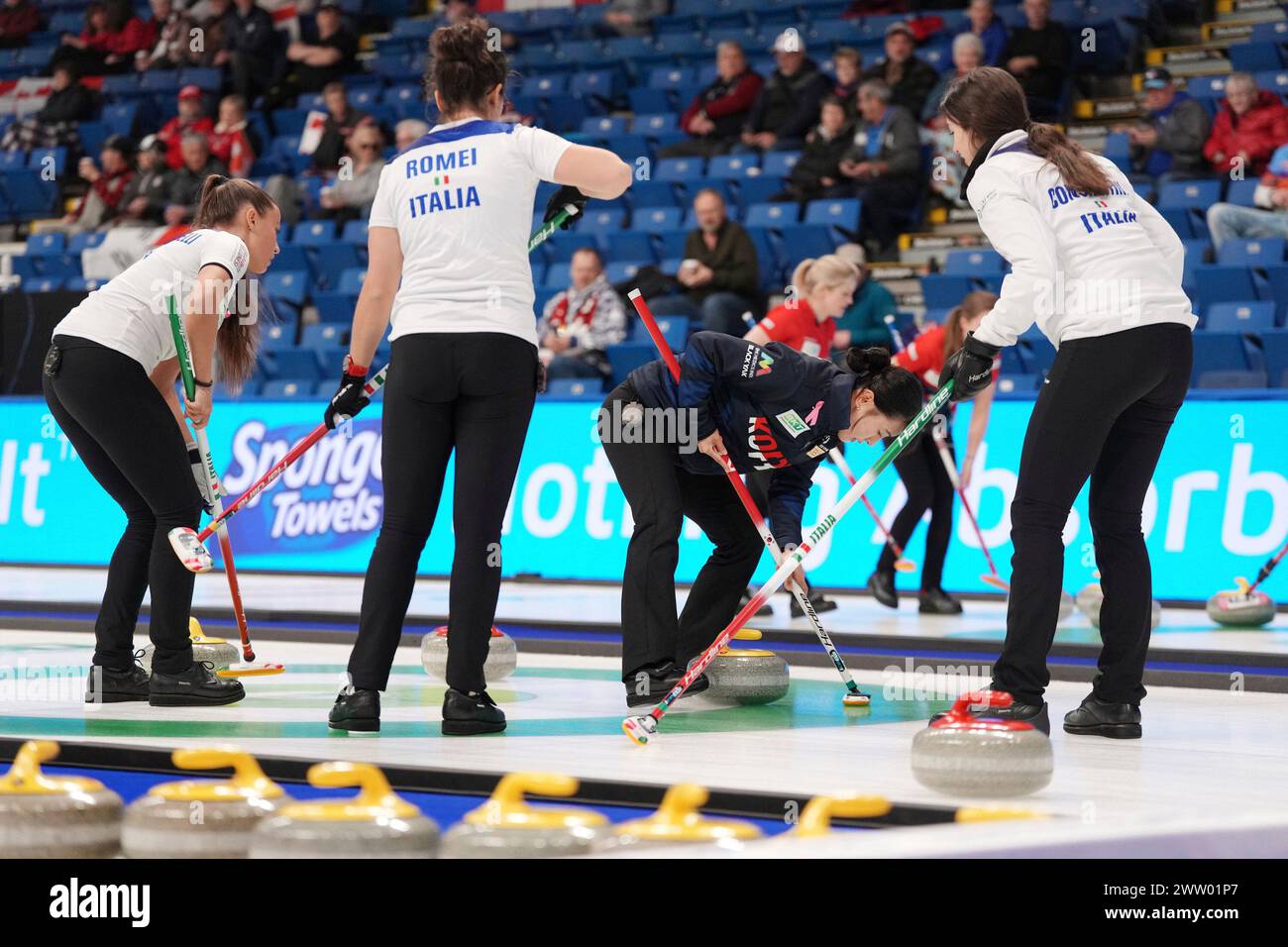 South Korea skip Eunji Gim, second from right, tries to sweep a stone ...
