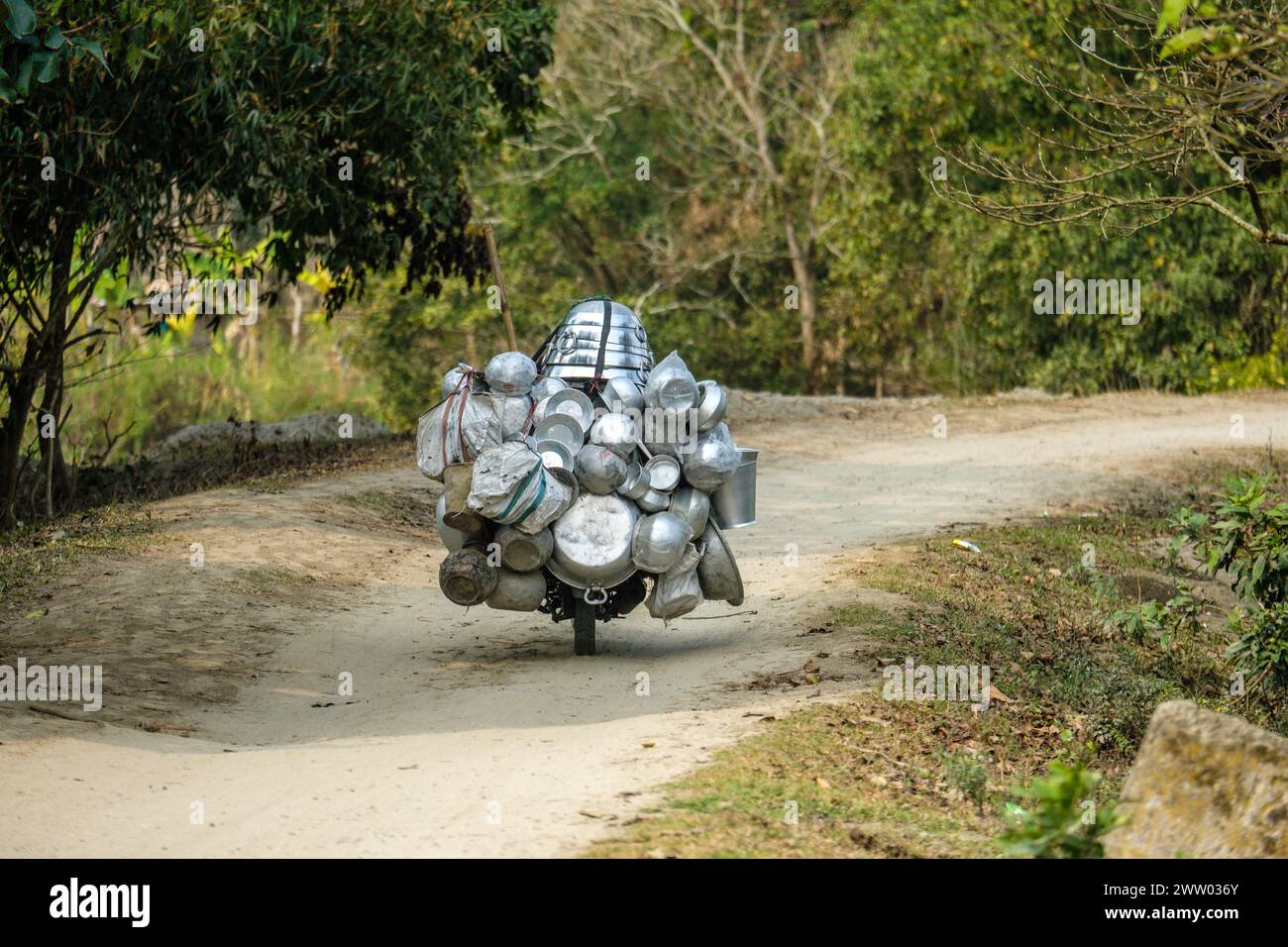 Pots and pans being sold from an overloaded motorcycle on Majuli Island ...
