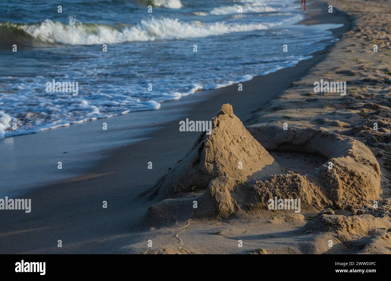 Sand castle on a sandy sea beach. Sunny day on the beach, sea view and ...