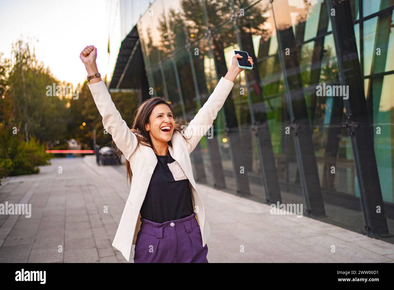 Smiling businesswoman feeling excited after finnshing work Stock Photo ...