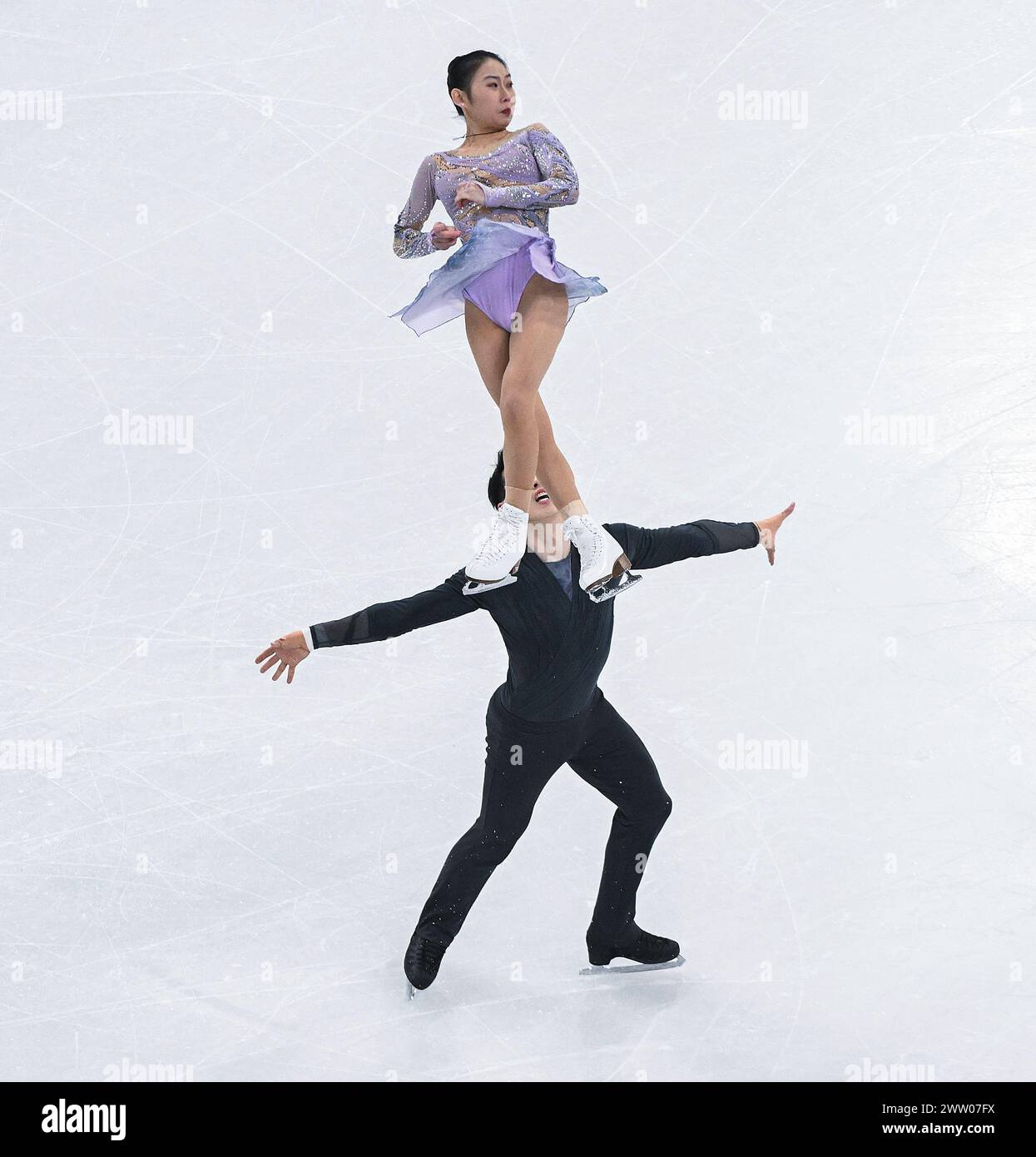 Cheng Peng and Lei Wand, from China, perform their pairs short program ...