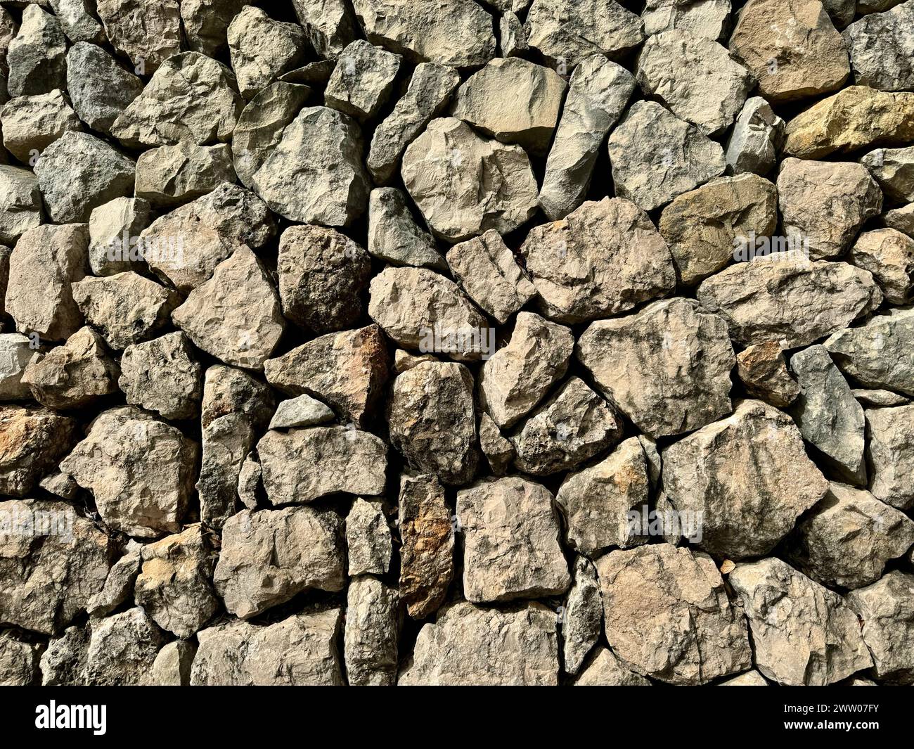 Texture of a rock wall built with the ancient dry stone technique. All ...