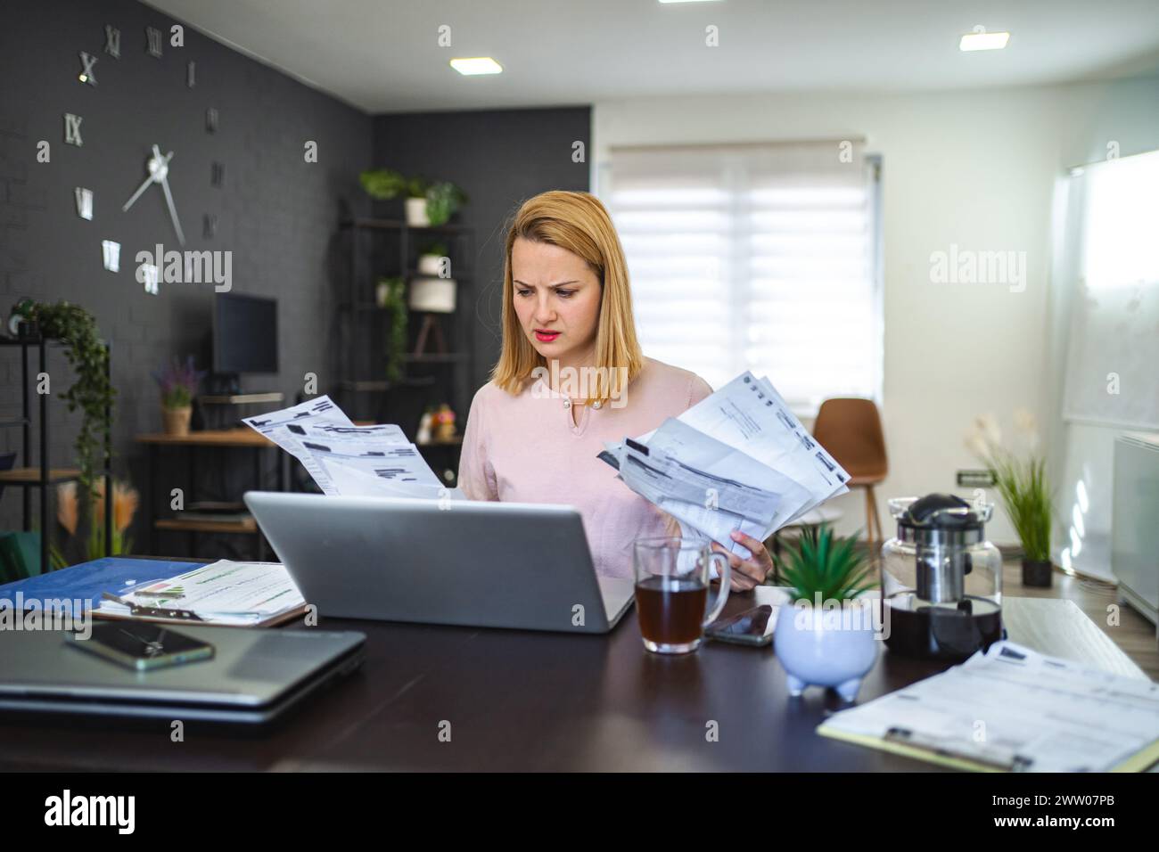 Blonde woman working with a lot of paperwork Stock Photo - Alamy