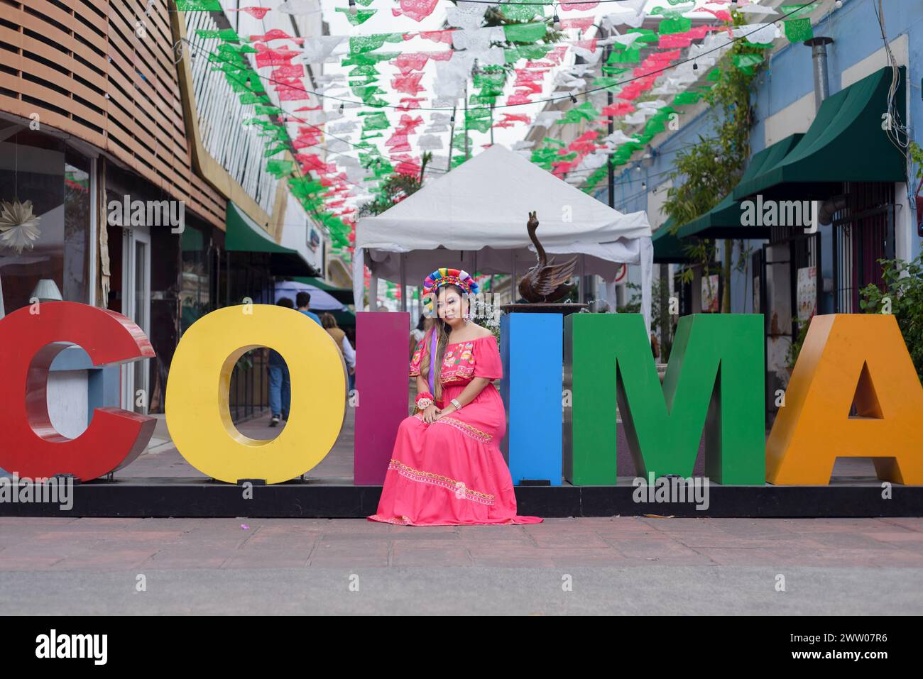 Mexican woman wearing traditional costume next to the giant letters of ...