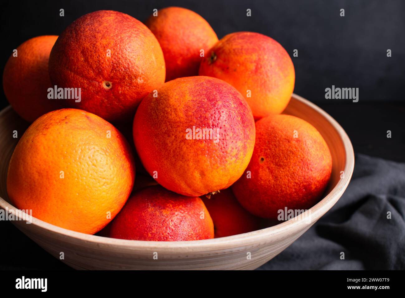 Side View of Blood Oranges in a Bowl: Several whole raspberry oranges ...