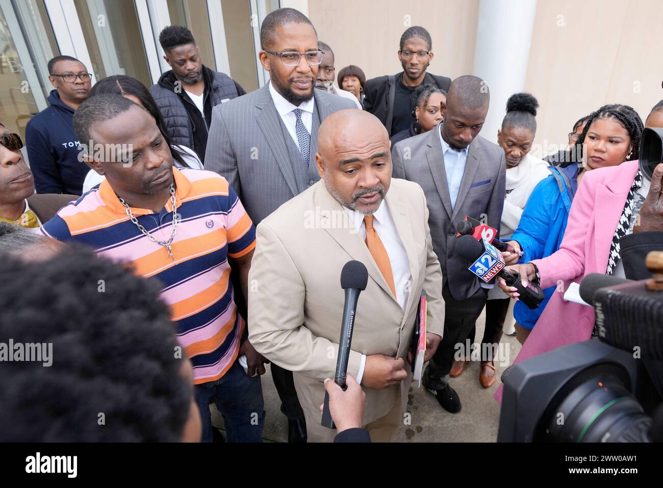 Civil co-counsel Trent Walker, center, speaks to reporters on the ...